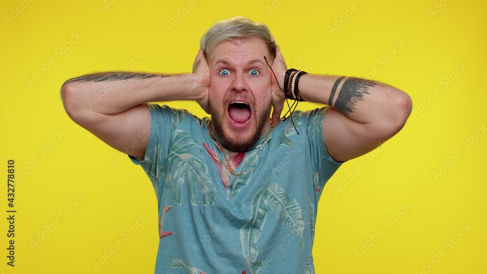 Bearded adult guy scared fearful, covering ears with hands, closing ...