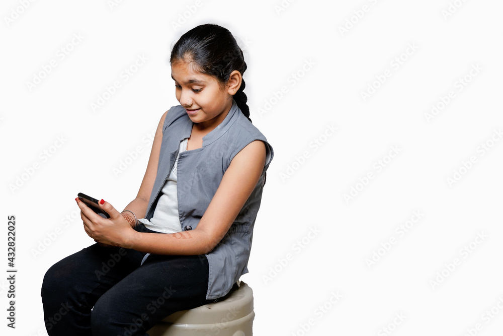 indian Female child using smart phone on white background Stock Photo ...