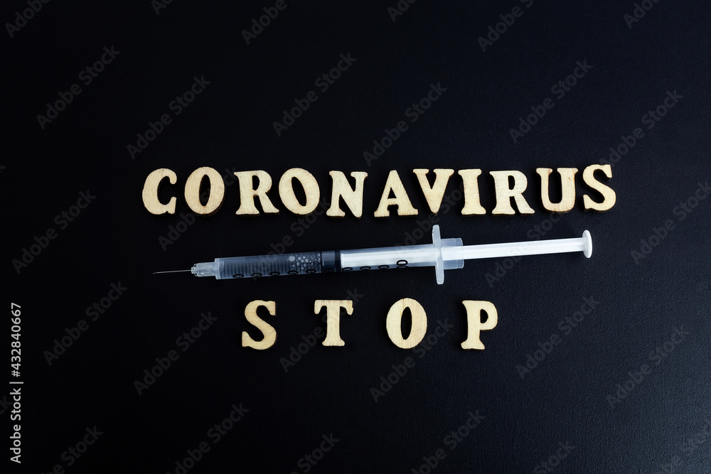 one syringe with a dose of medicine or vaccine on a black background ...