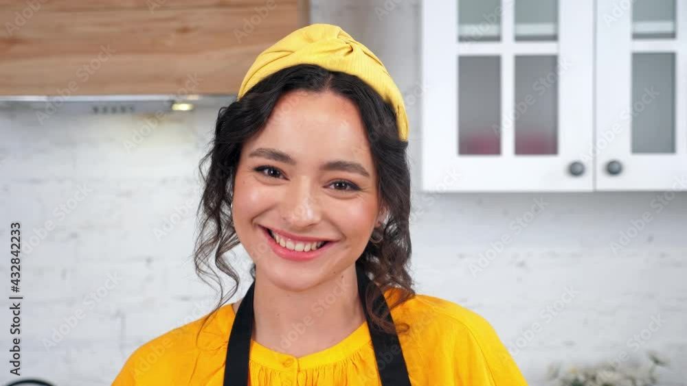 Close up laughing beautiful housewife looking at camera on home modern ...