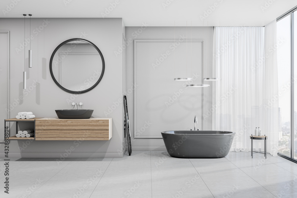 Front view on spacious bathroom with wooden furniture, round mirror ...