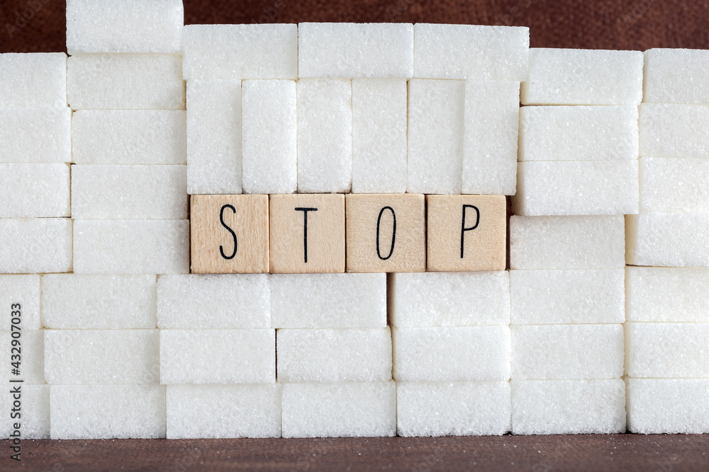 Pile or wall of sugar cubes and stop word in block letters as advise on ...