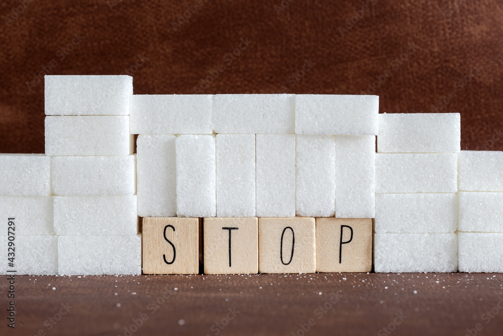 Pile or wall of sugar cubes and stop word in block letters as advise on ...