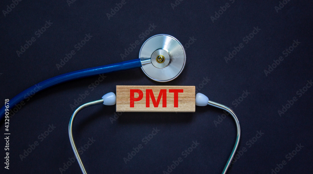 Medical and PMT, premenstrual tension symbol. Wooden block with the ...