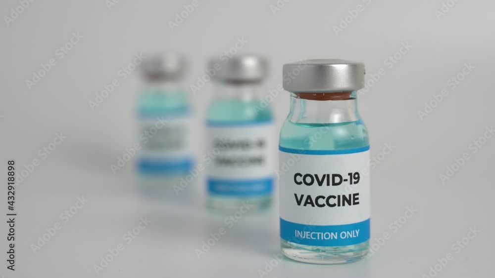 Close up of Covid-19 vaccine vials on white background. Focus moves ...