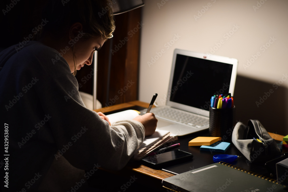Young teenage girl student studying late at night in her room Stock ...