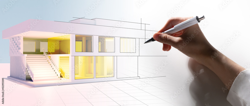 A person draws an image of the future house with a pen. A mock-up of a ...