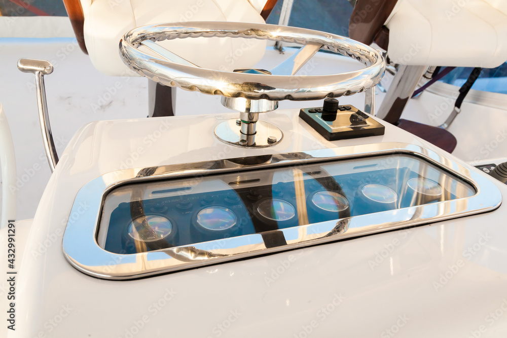 Internal control cabin of a motor yacht. Control panel, steering wheel ...