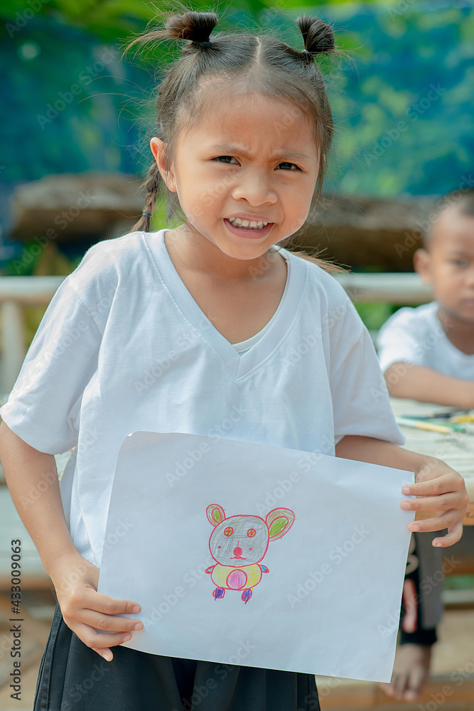 Little cute girl showing his painting on paper drawings with color ...