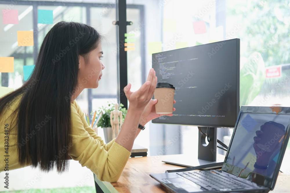 Developing programmer team typing source codes and Website design in ...