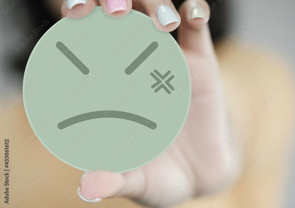 Hand holding green paper cut angry face, negative thinking, mental ...