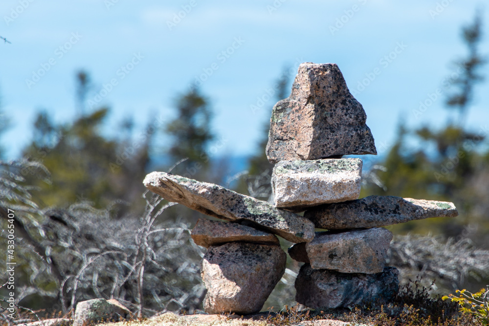 Inukshuk, a stack of granite rocks in the form of a person. The ...