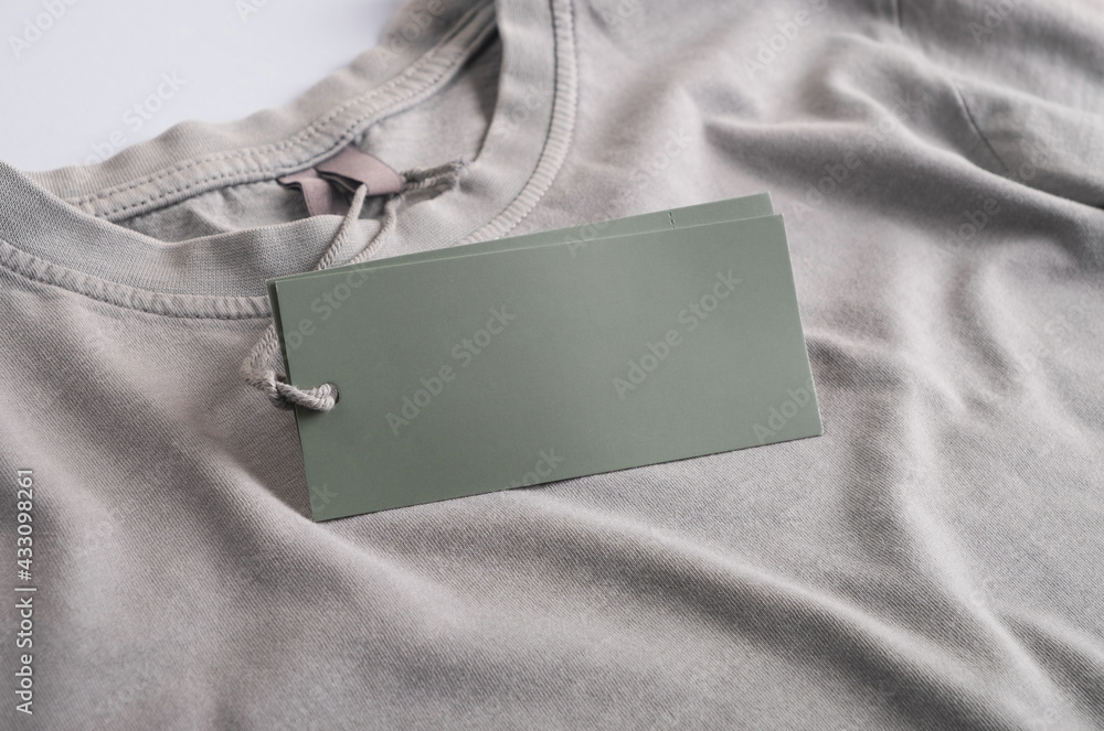 Empty tag card or label mockup for design on gray clothes. Branding ...
