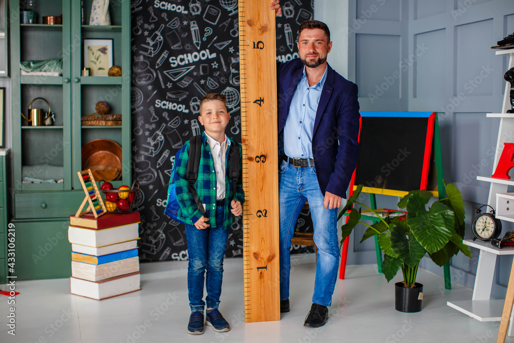 Father takes child to school. Back to school concept. Schoolboy go to ...