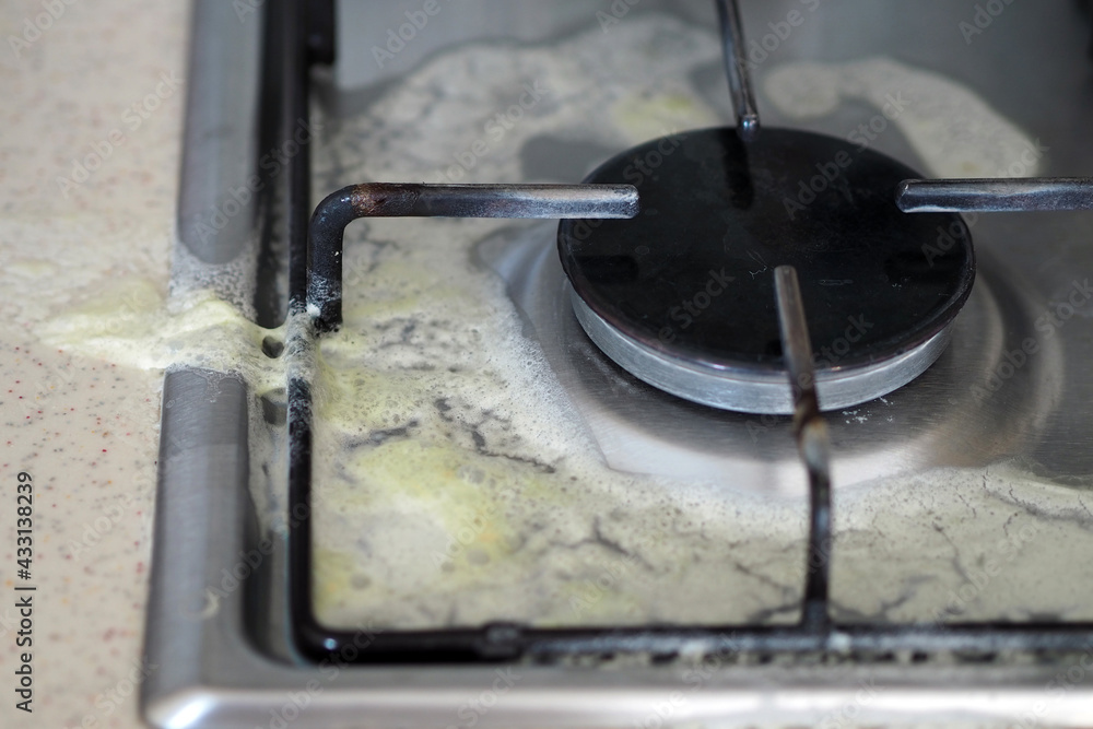 milk overflowed on the cooking stove and it got dirty, Stock Photo ...