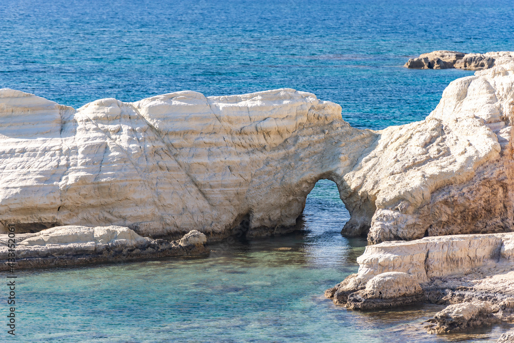 Bays and bays of Cyprus. Rocks with a through passage. Blue waters of ...
