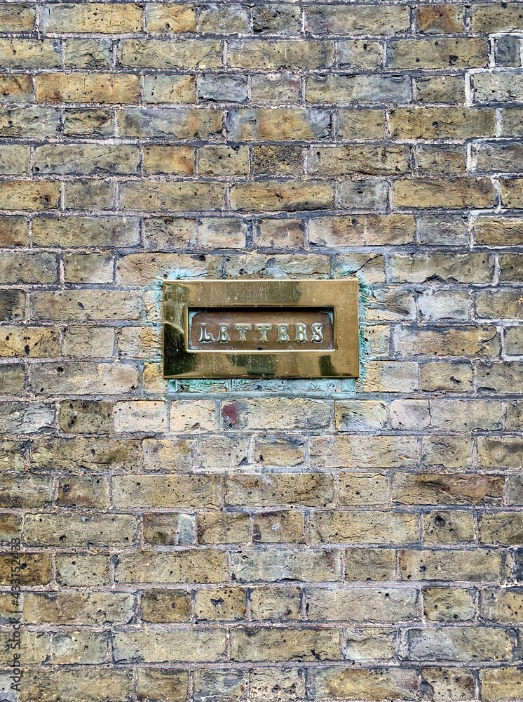 LONDON, ENGLAND. Brick wall with vintage letter hole for envelopes and ...