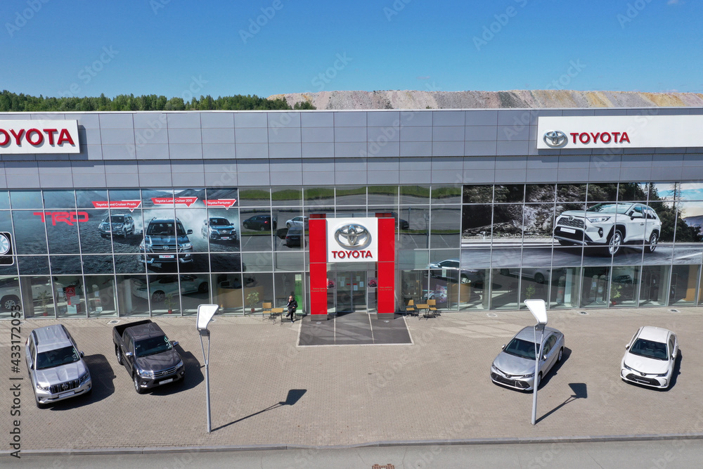 Toyota dealership with modern facade and cars on display in front of ...