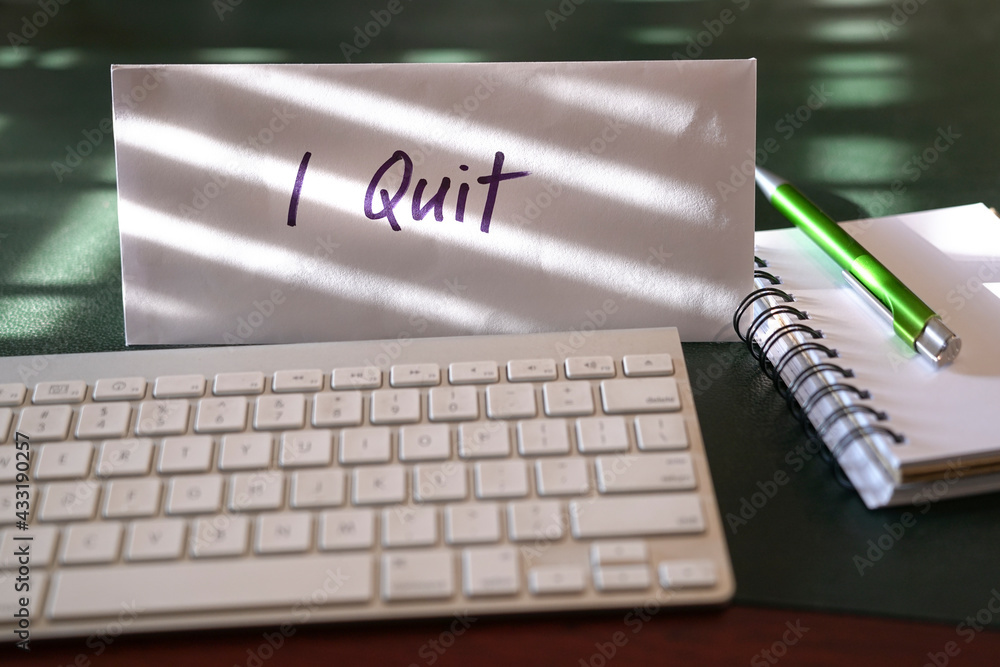 Resignation letter with words I quit on the envelope, in front of ...