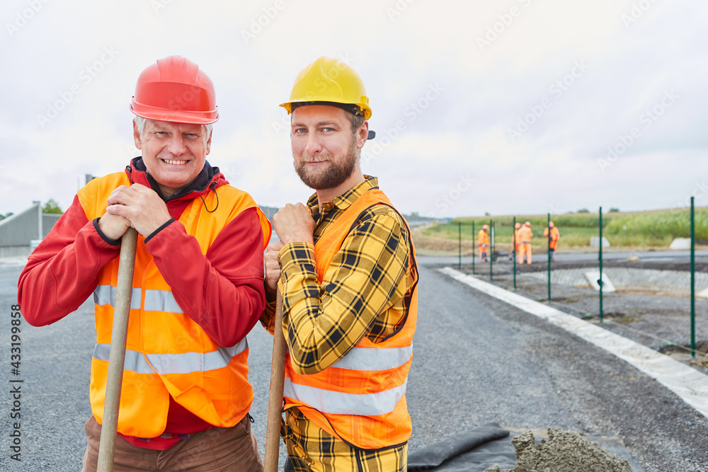 Two workers as road builders on the construction site Stock Photo ...