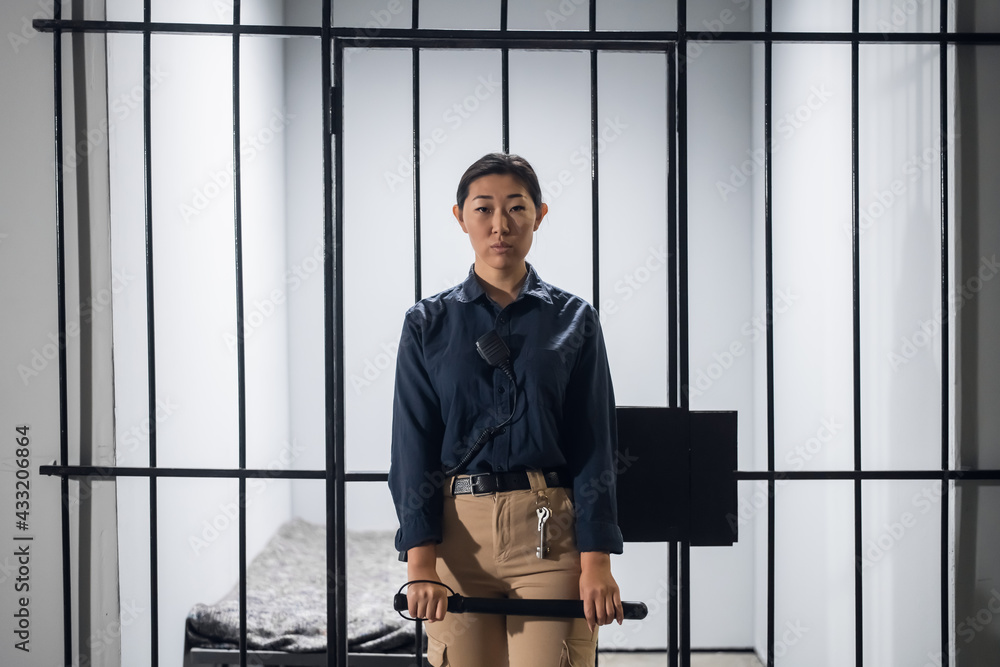 Asian guard in uniform In full armor with a baton and a pistol on the ...