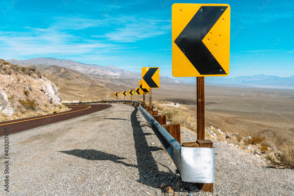Yellow arrow road signs on the road in Death Valley, USA Stock Photo ...
