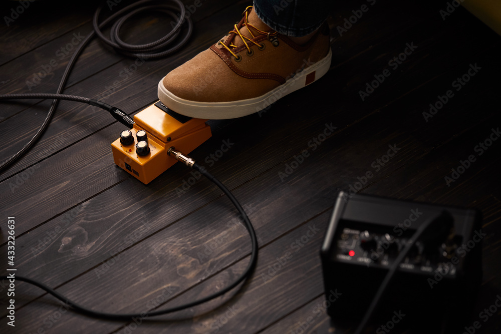 Guitarist foot wearing sneakers using guitar pedal Stock Photo | Adobe ...