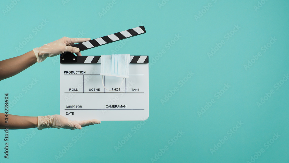 Clapper board or movie Clapperboard or slate with face mask in hand ...