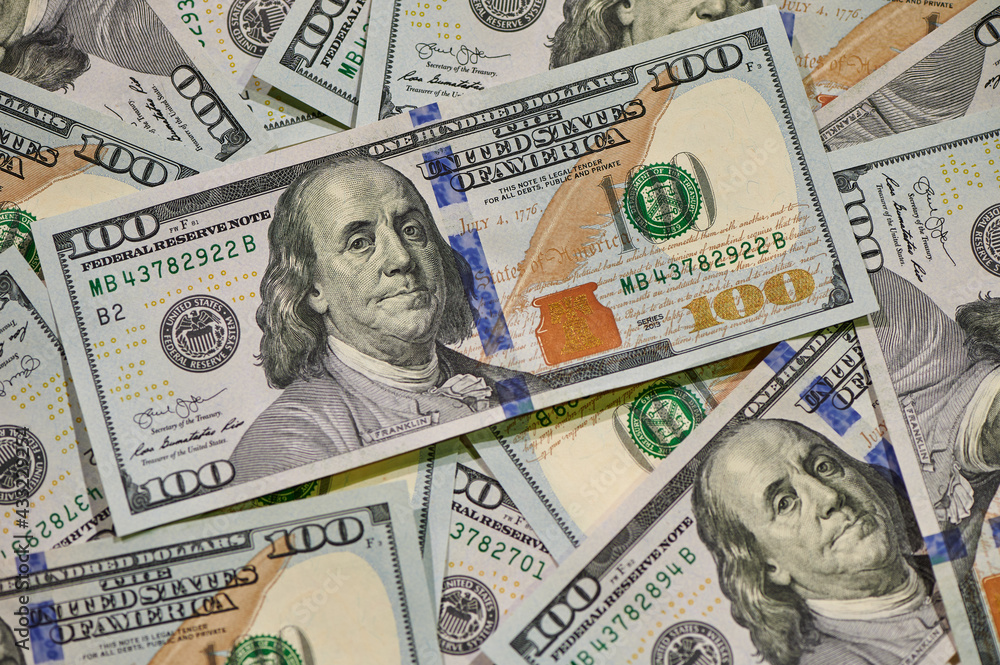 Cash of hundred dollar bills. Stock Photo | Adobe Stock