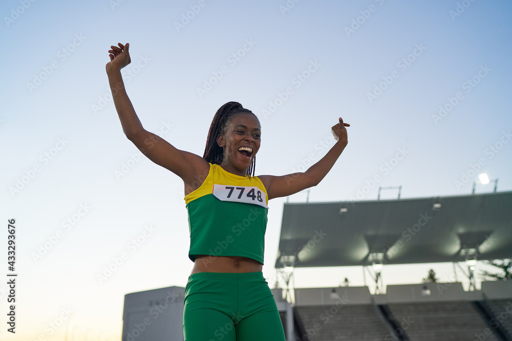 Happy female track and field athlete celebrating at competition Stock ...
