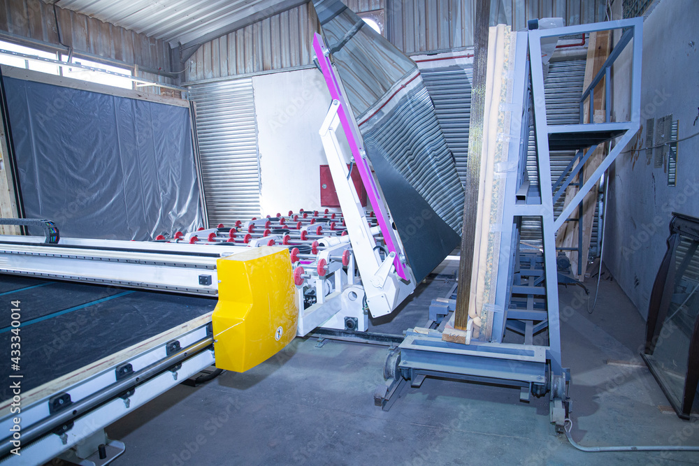 machines working with giant glasses in industrial glass window ...