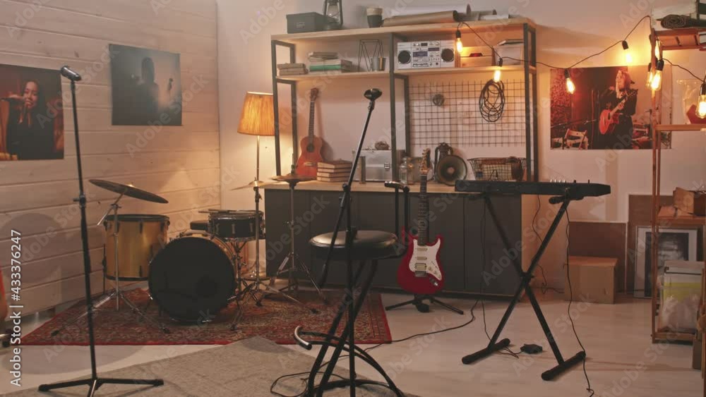 PAN overview of small cozy garage turned into vintage music studio with ...