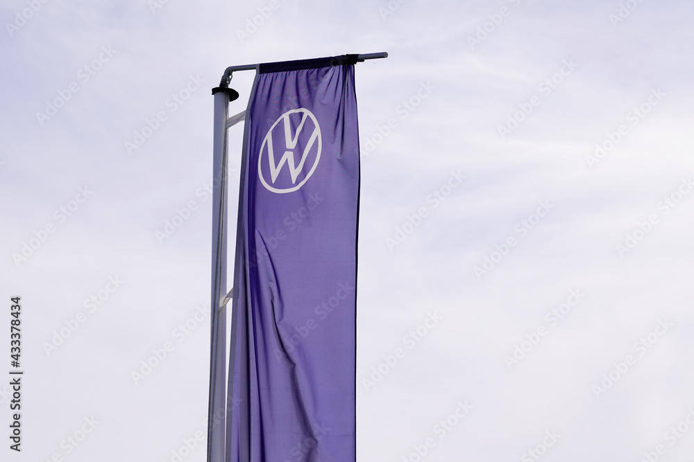 Volkswagen new sign vw logo car brand on flag blue front of vehicle ...