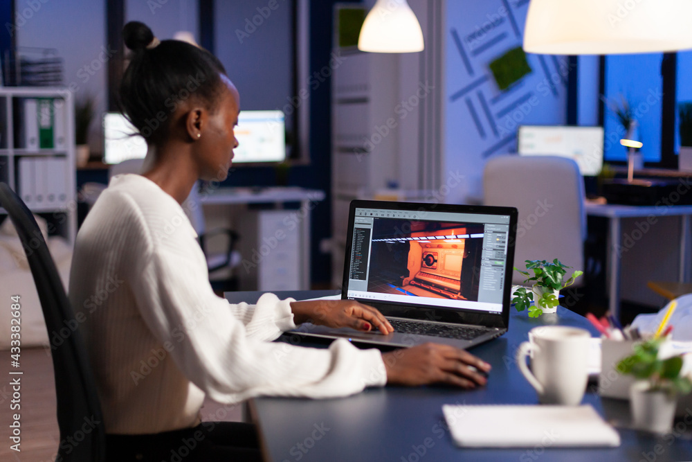 Dark skin gamer developer working at video game in midnight from ...