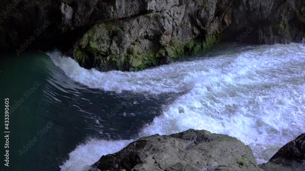 Water flowing in huge limestone cave in Slovenia. Karst underground ...