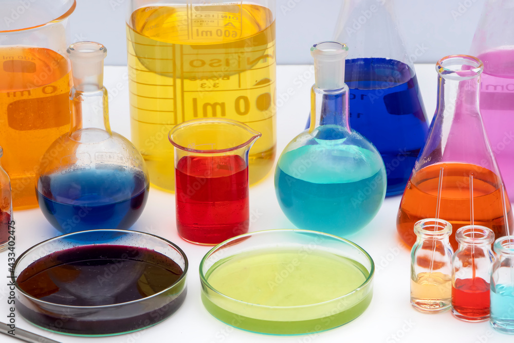 Laboratory glassware with various colored liquids in chemistry ...