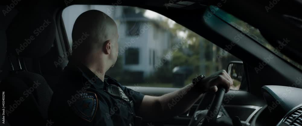 DX Daytime shot of Caucasian American police officer patrolling streets ...