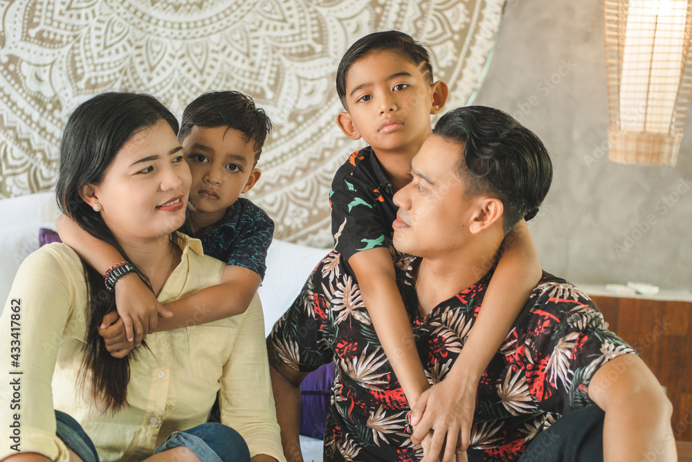 Southeast Asian family spending time at home. Happy Indonesian or ...