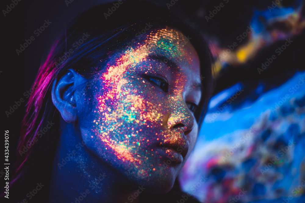 Beautiful young woman dancing and making party with fluorescent ...