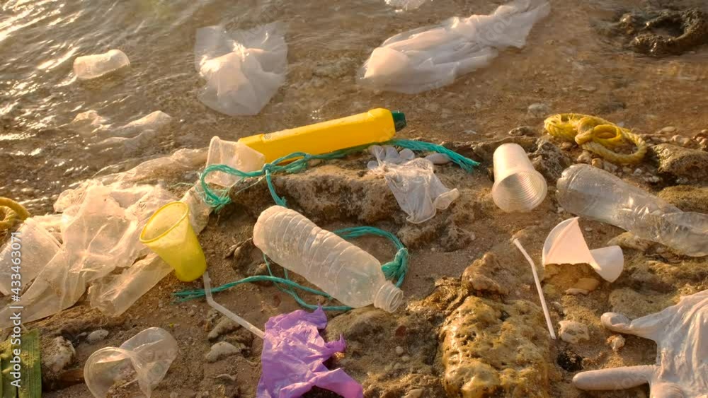 Close-up of disposable plastic, face masks and other debris on the ...