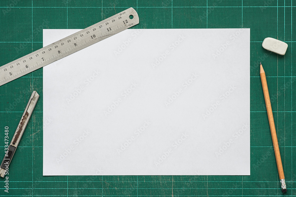 Old green dirty cutting mat, with empty white paper A4 size, stainless ...