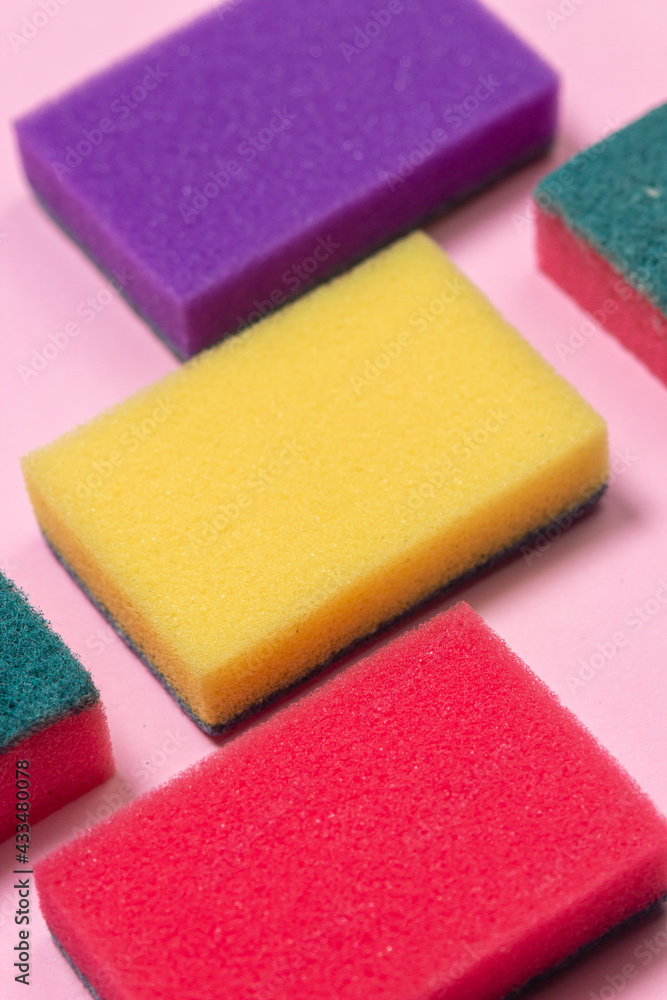 Washing sponges on a pink background. Cleaning sponges on a colored ...