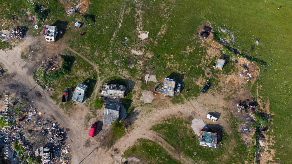 Aerial drone view of Romani people settlement. Small barracks. Roma ...