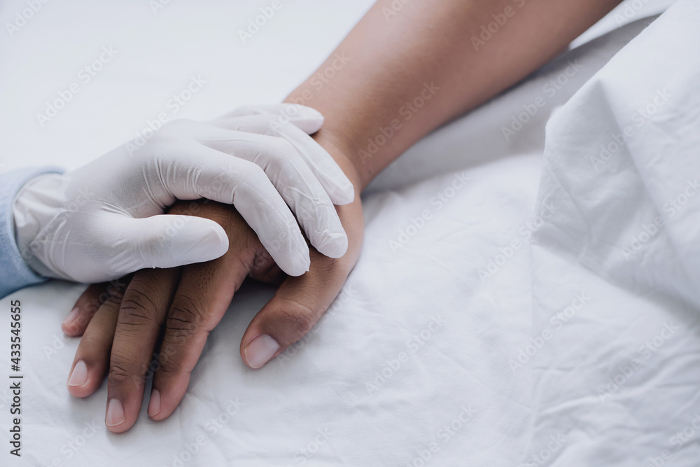Doctors wear medical gloves holding touching hands man patient with ...