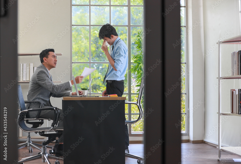 A young junior employee feels sad and crying when the boss blame and ...