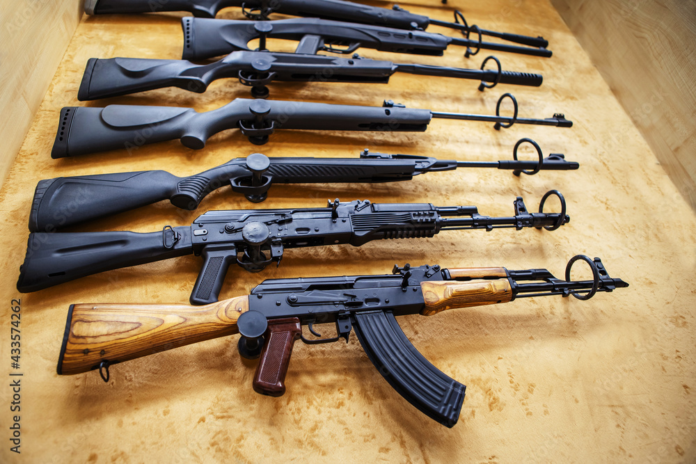 Pneumatic guns on a shop window. Trade in sports weapons of various ...