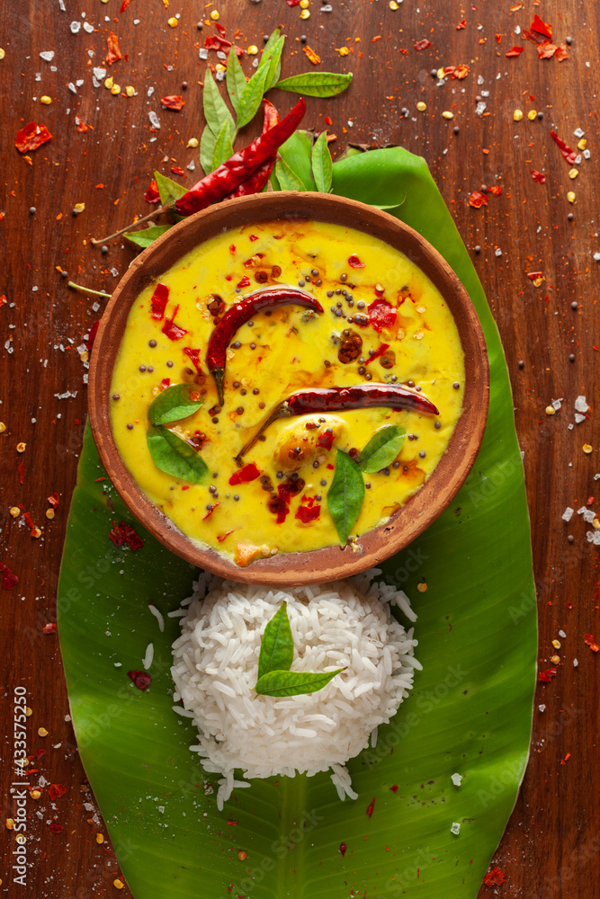 Close-up of Indian cooked rice with kadi or kadhi over the banana fresh ...