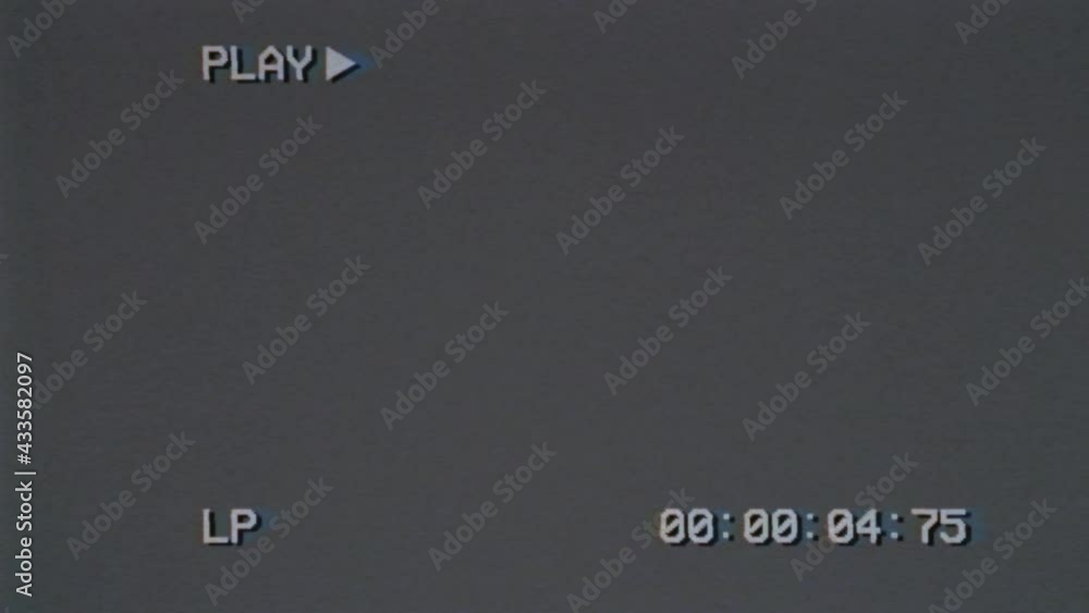 Old gray screen with PLAY text and timecode. VHS glitches and static ...