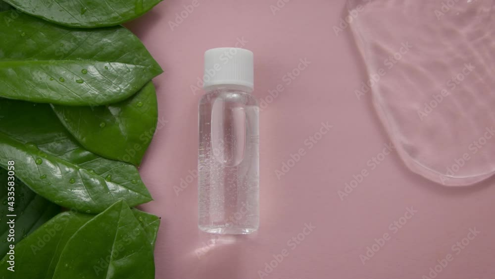 Cosmetic bottle with transparent gel liquid in clean water splash on ...