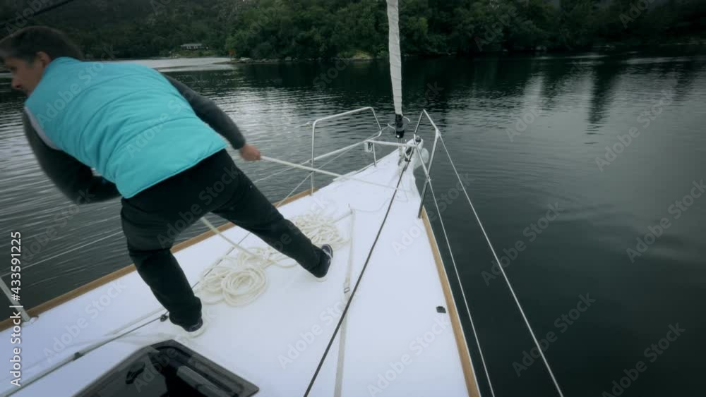 Video Stock Male pulling rope parking yacht at marina bay with ...